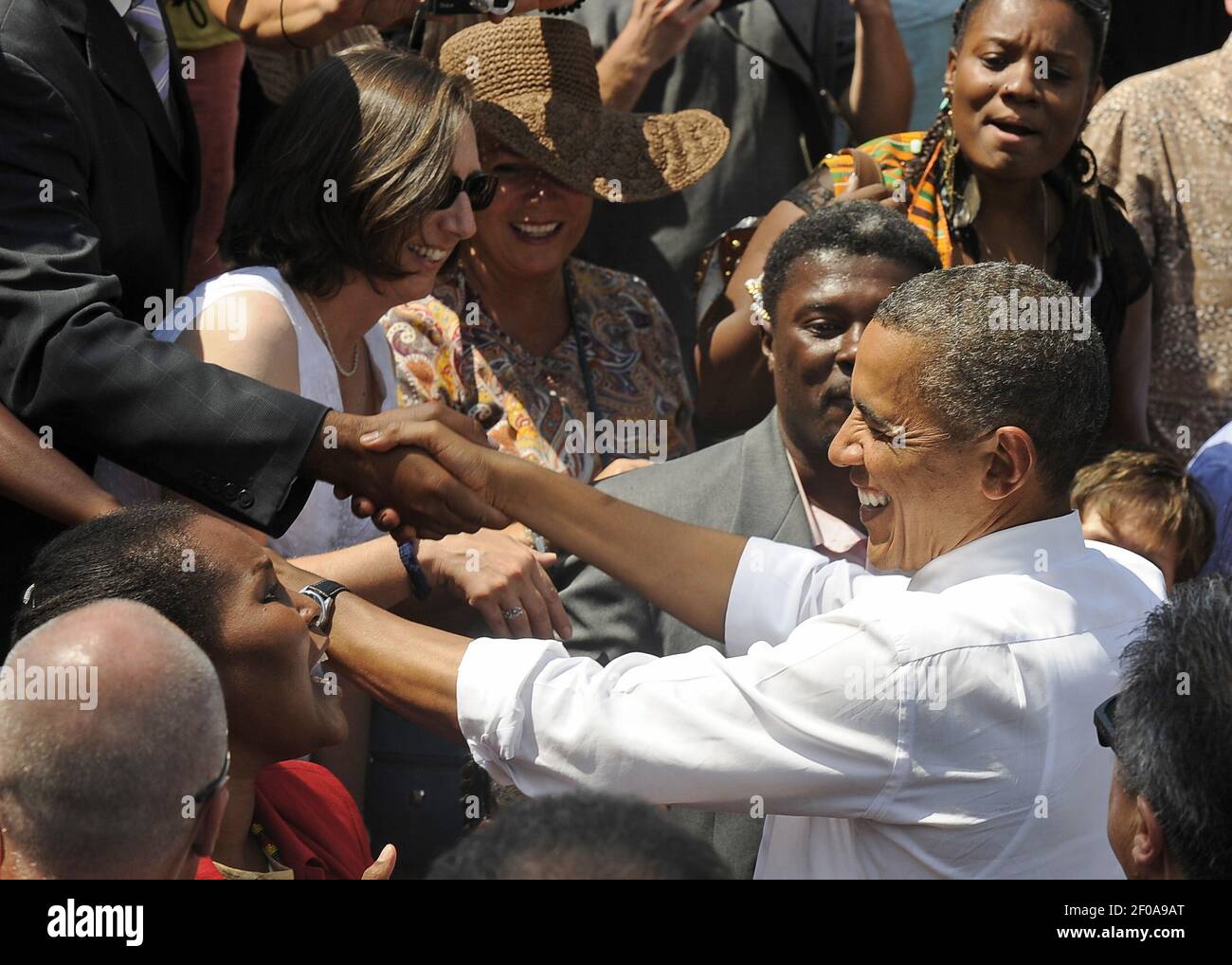 President Obama reaches out to the crowd after making a campaign speech ...