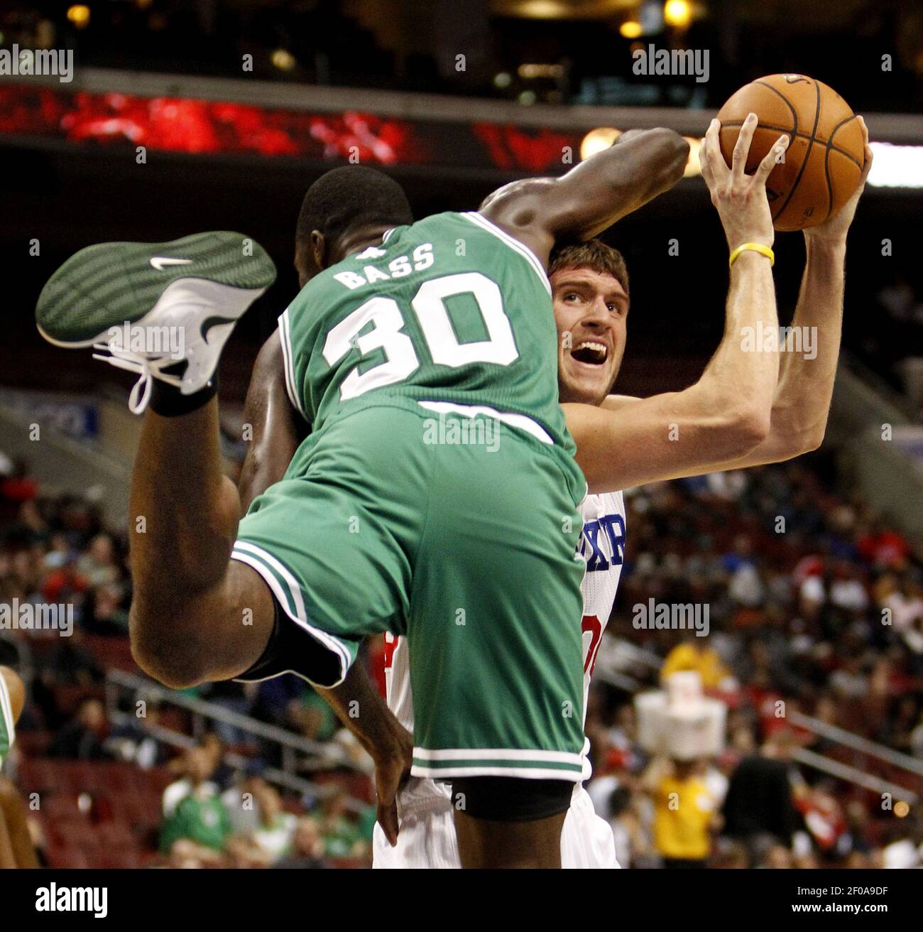 Philadelphia 76ers' Spencer Hawes is fouled by Boston Celtics' Brandon ...