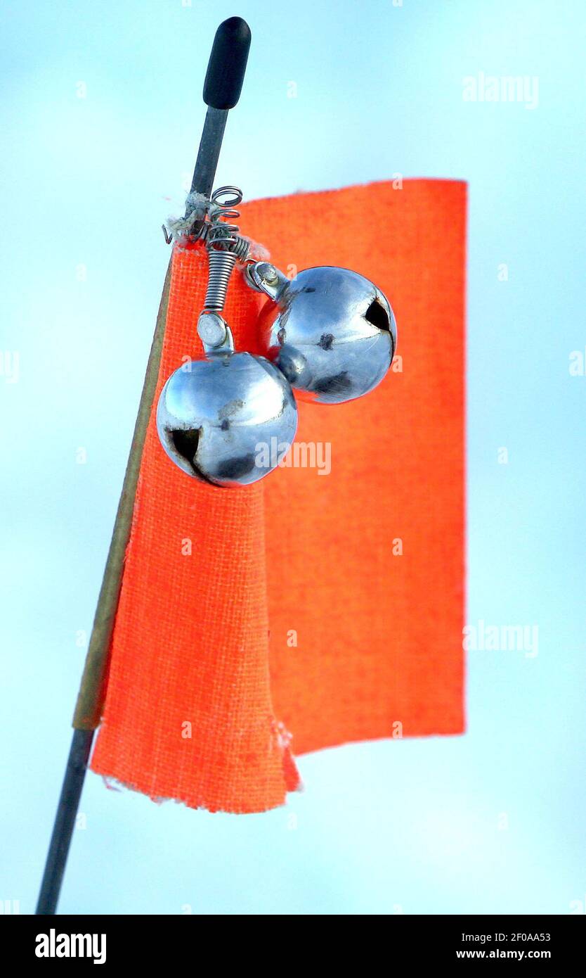 Steve Foss, of Ely, Minnesota, adds bells to his tip-up flags so that ...