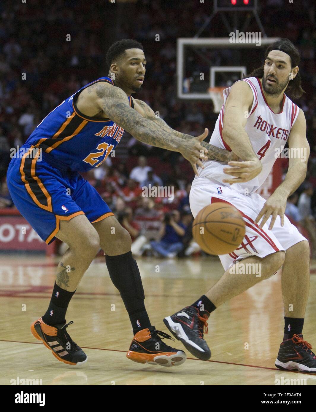 Luis Scola (4) of the Houston Rockets passes the ball by the defense of ...