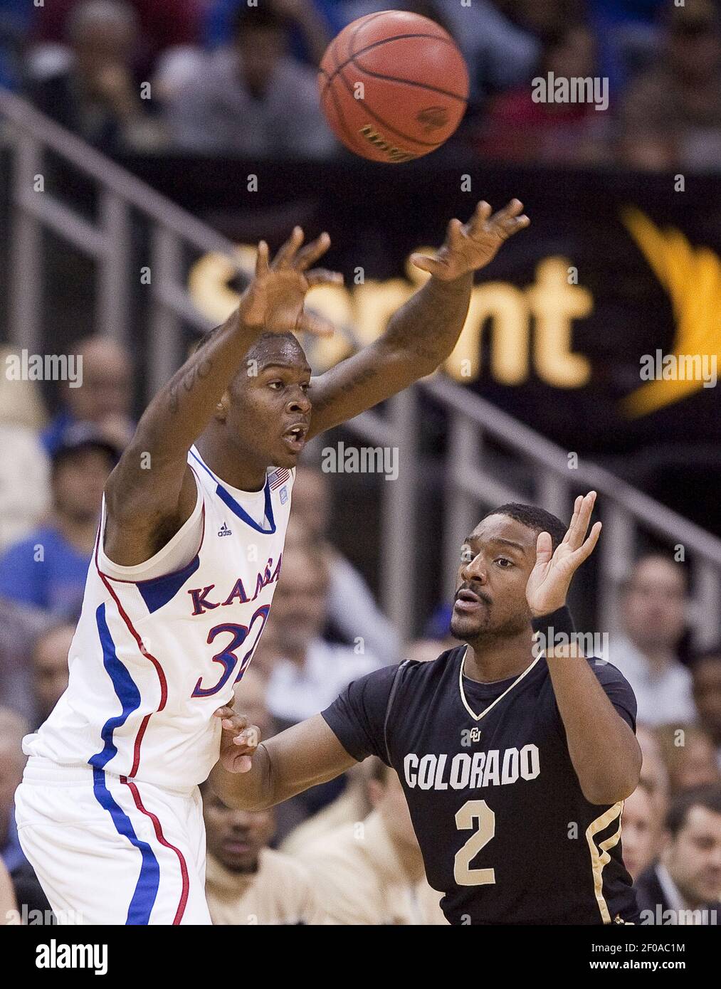 Kansas' Josh Selby delivers a pass as Colorado's Shannon Sharpe (2 ...