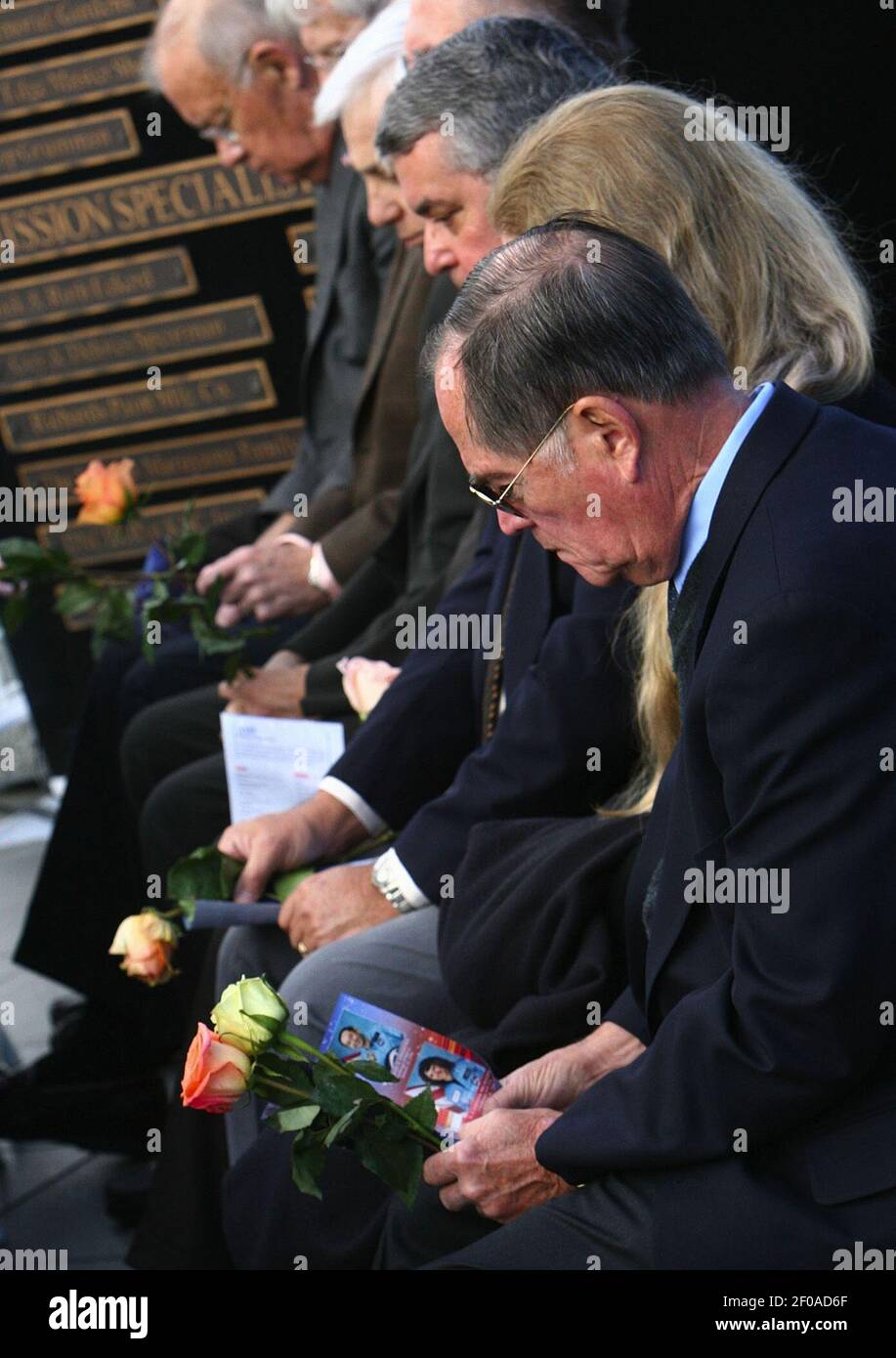 Bob Crippen, front, the first space shuttle pilot, bows his head in ...