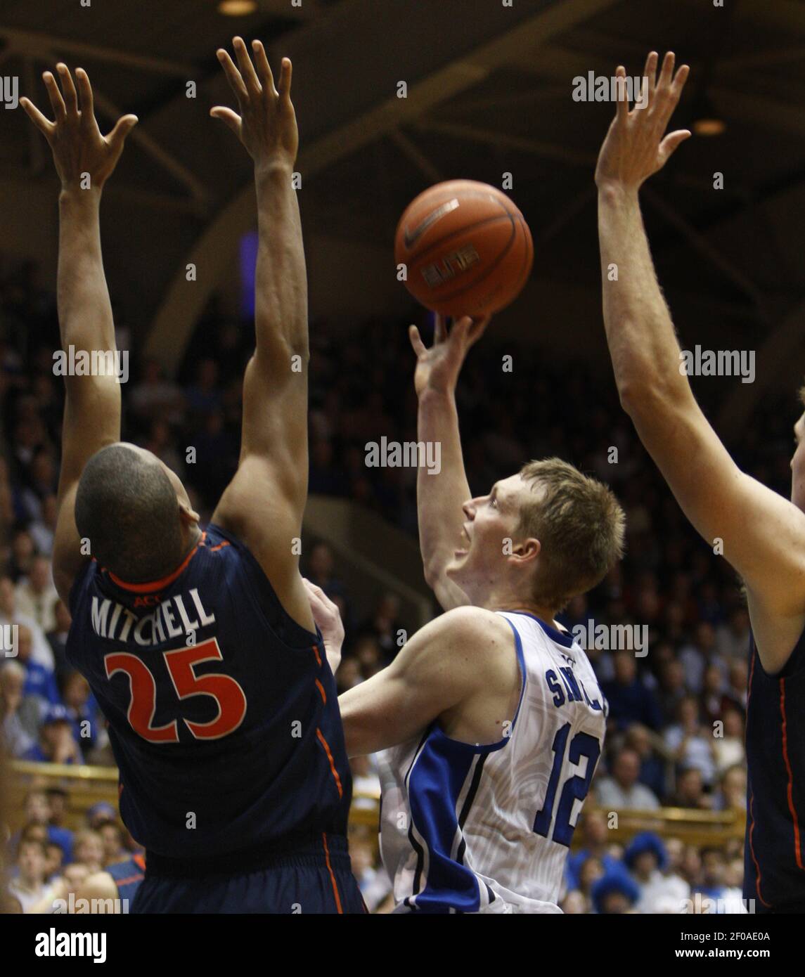Duke forward Kyle Singler (12) shoots around Virginia forward Akil ...
