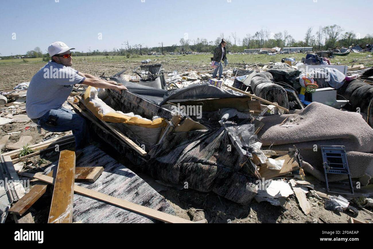 Justin Dunlow tries to move debris from what used to be his home in ...