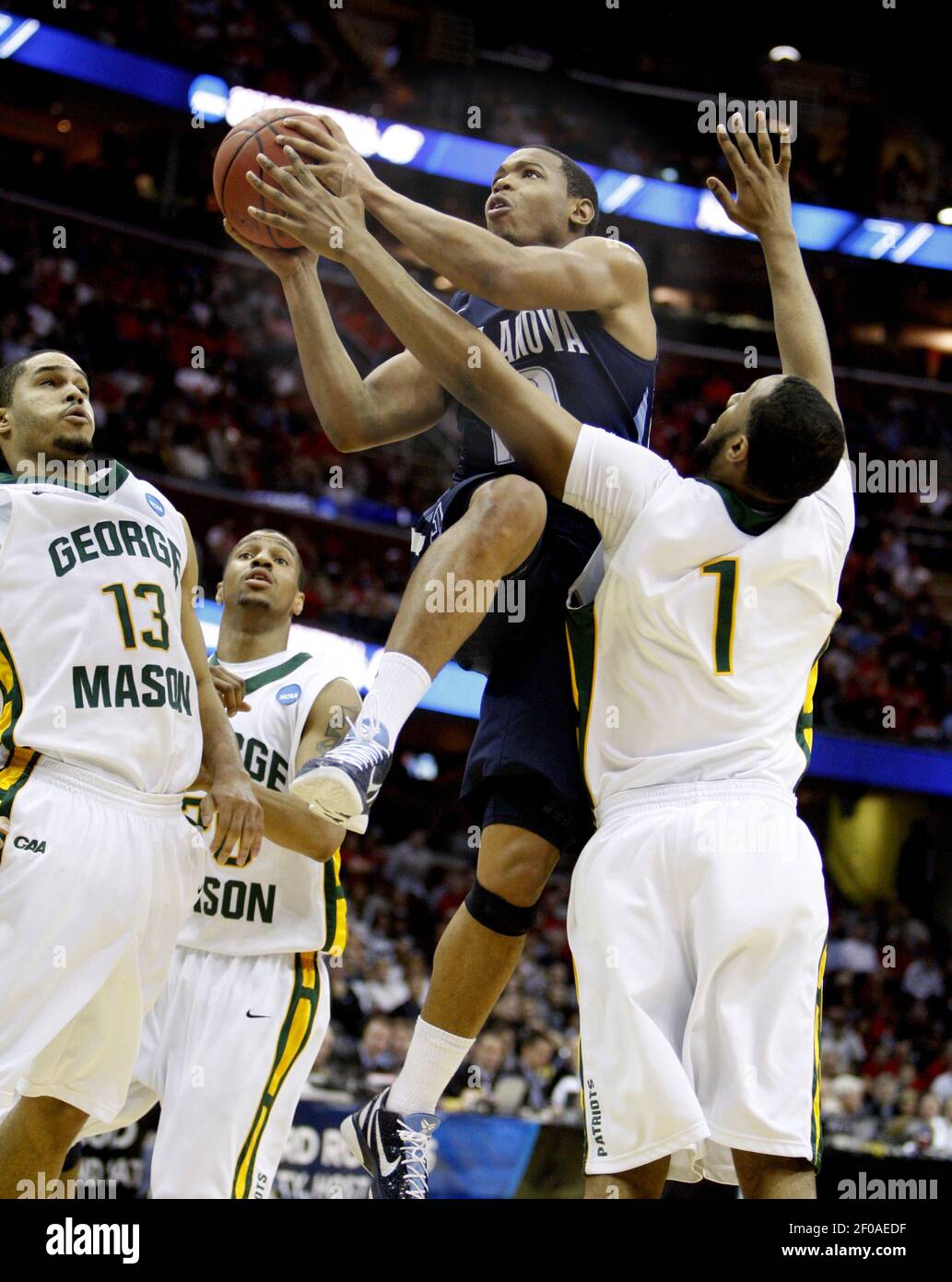Villanova's Corey Fisher is fouled by George Mason's Paris Bennett as ...