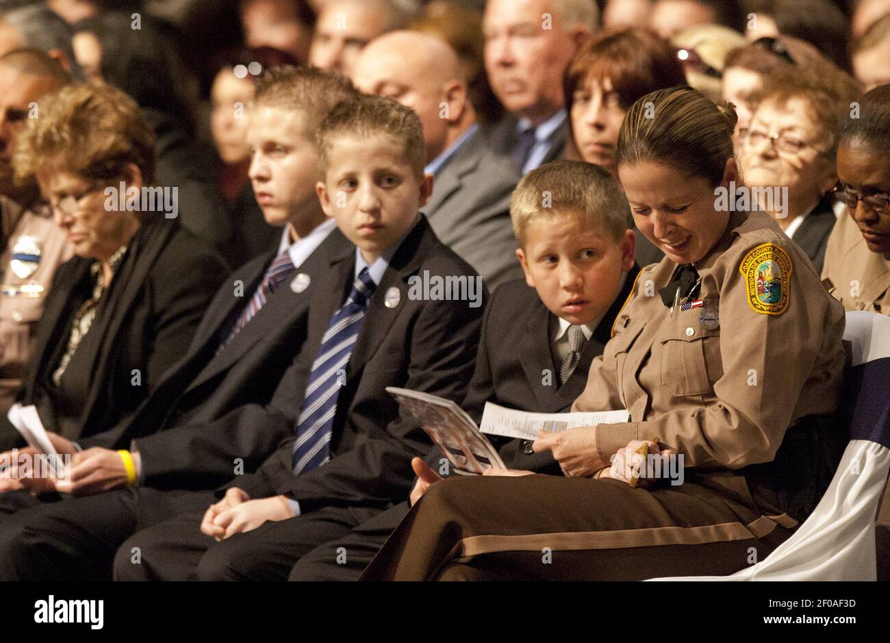 Officer Roger Castillo's widow Debbie grieves as her sons Anthony ...