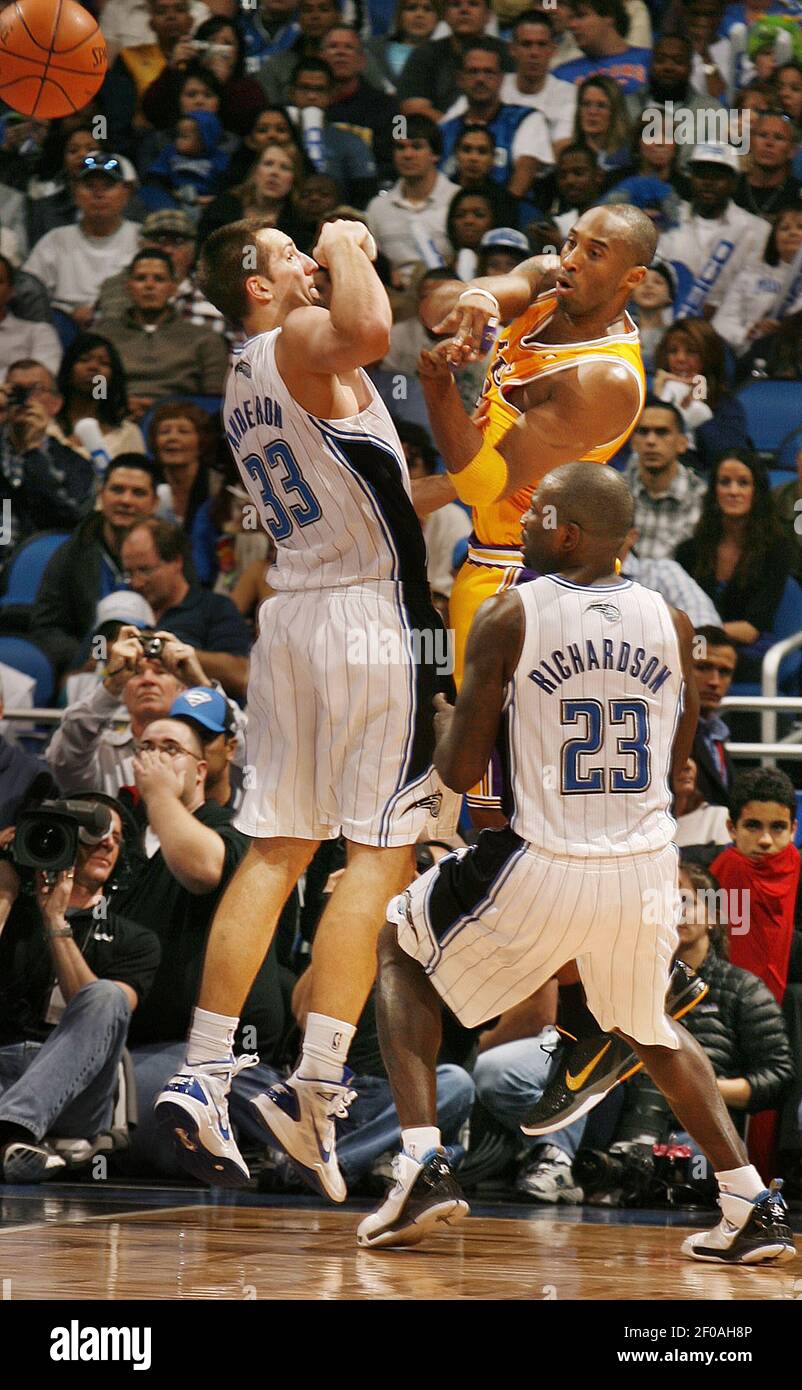 Los Angeles Lakers guard Kobe Bryant passes the ball between Orlando ...