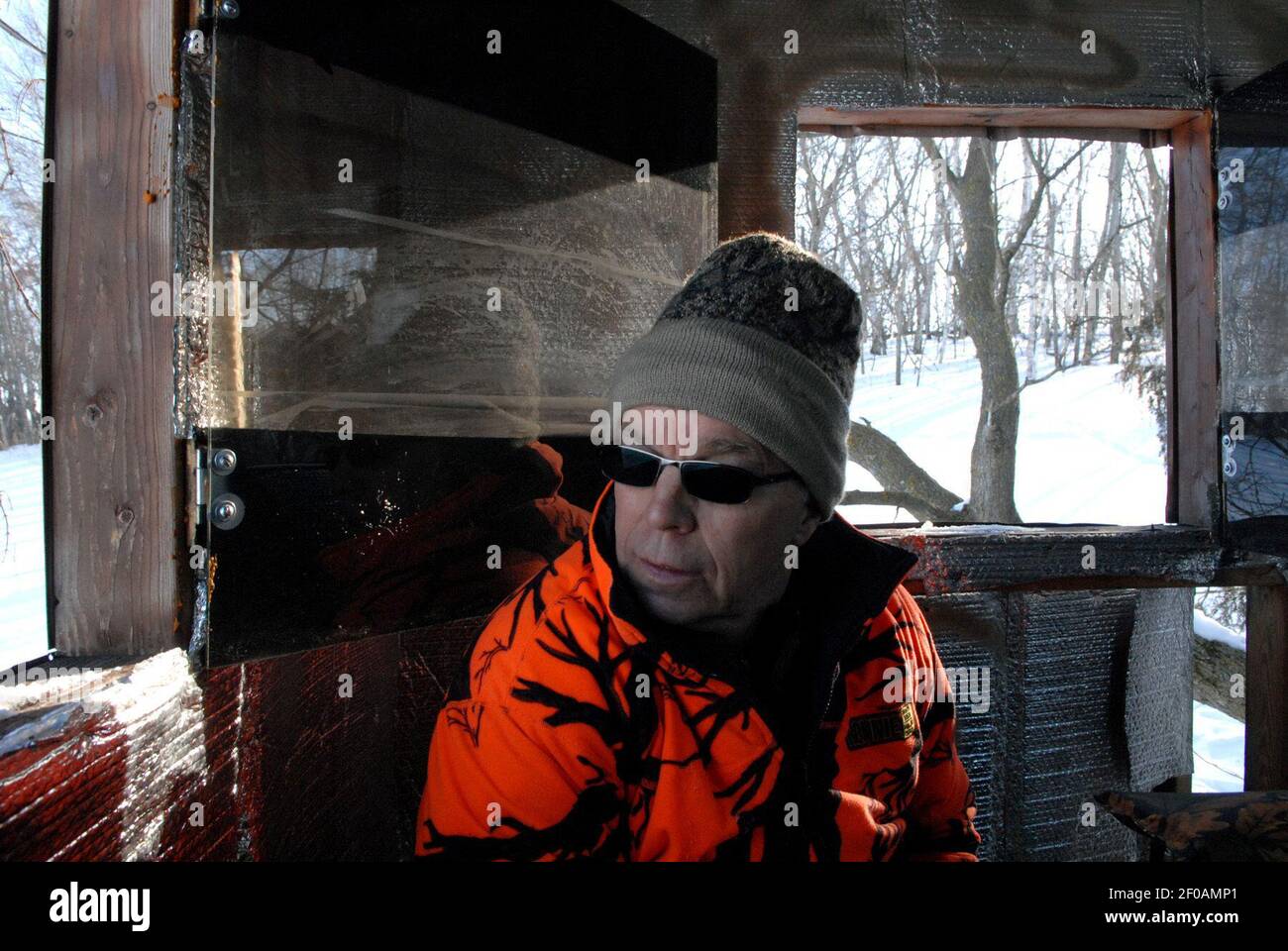 Ron Schultz sits in an enclosed deer stand overlooking 160-acres he ...