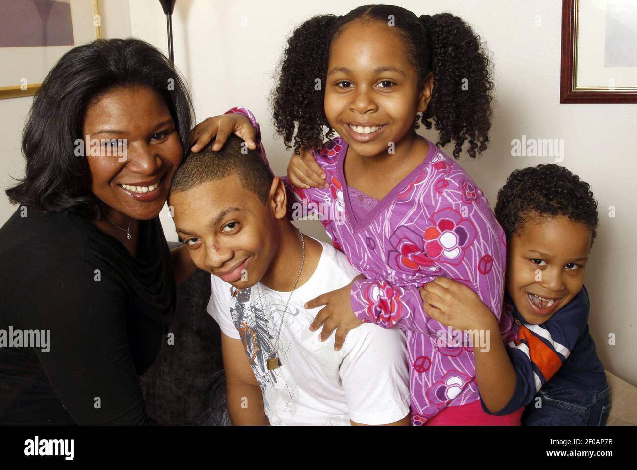 Tammy McCann, left, poses for portrait with three of her four children ...