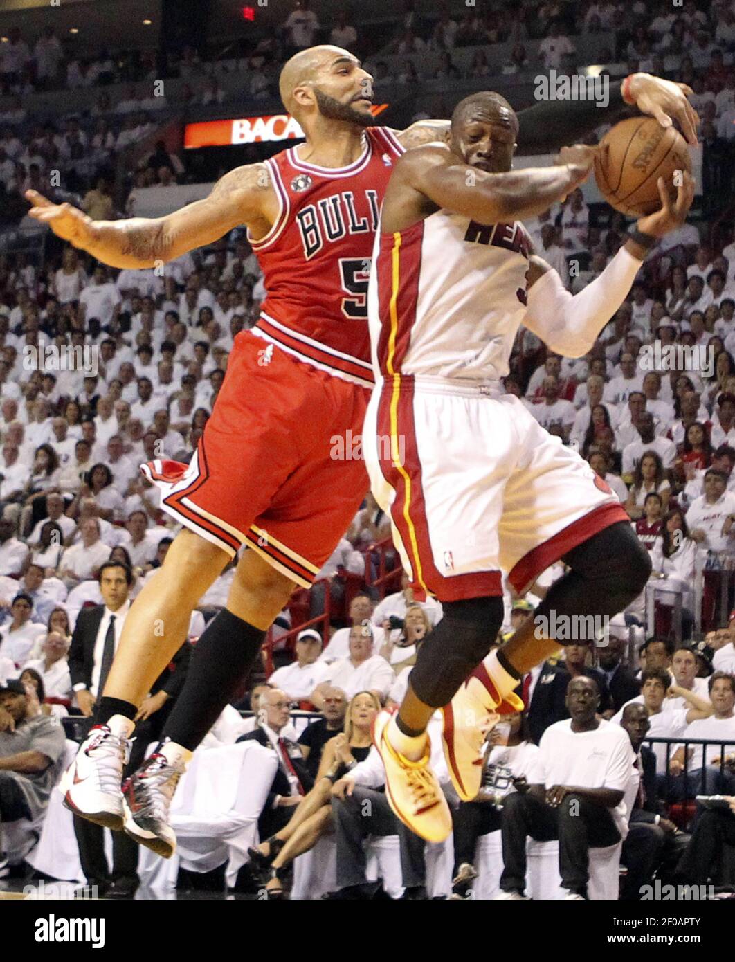 Miami Heat's Dwyane Wade is fouled by Chicago Bulls Carlos Boozer ...