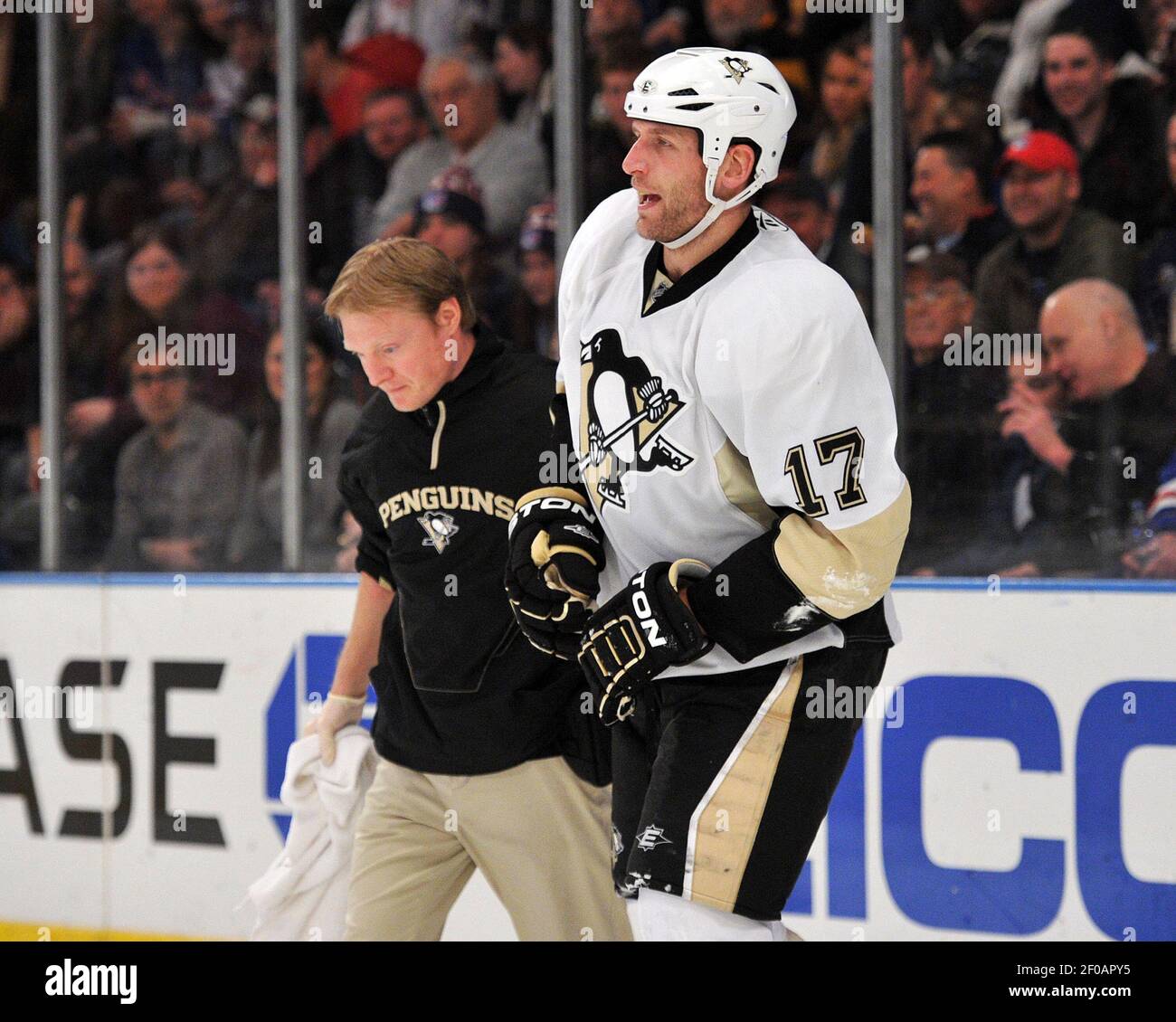 Pittsburgh Penguins center Michael Rupp (17) is escorted off the ice by ...