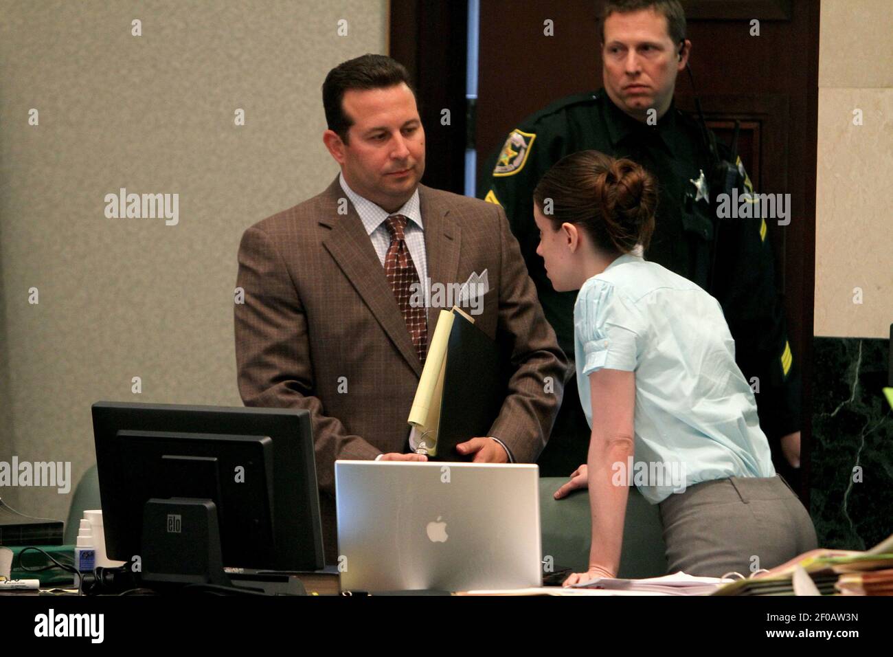 Attorney Jose Baez, left, listens to his client, Casey Anthony, during ...