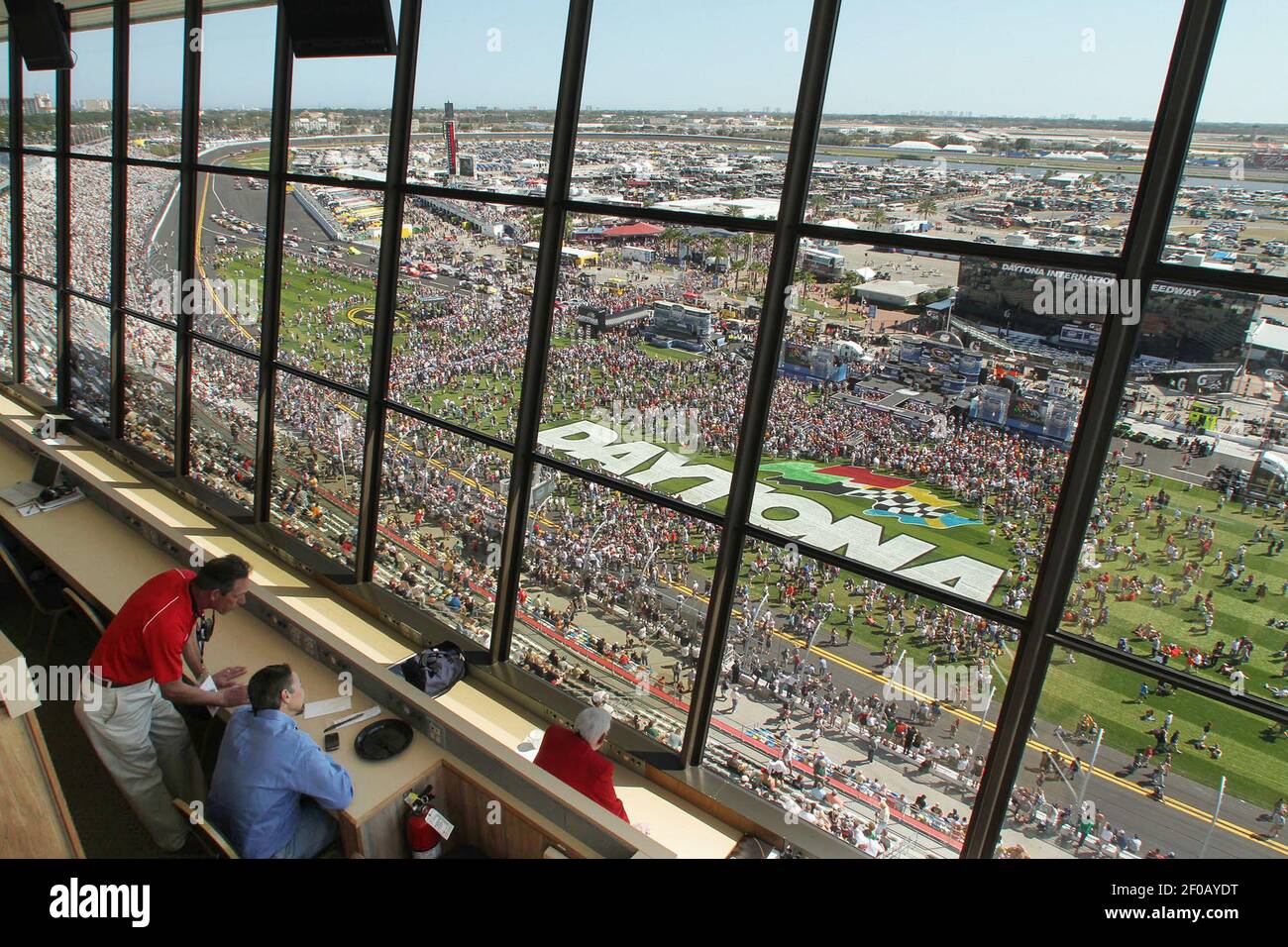 Spectators crowd the tri-oval area near the start/finish line during ...