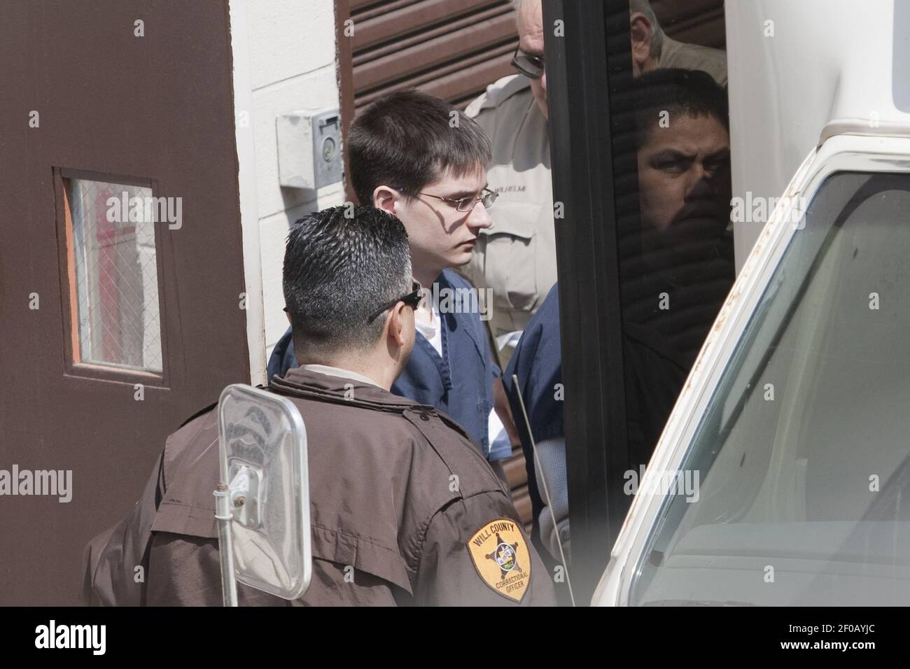 Keith Randulich steps onto a transport bus at the Will County ...