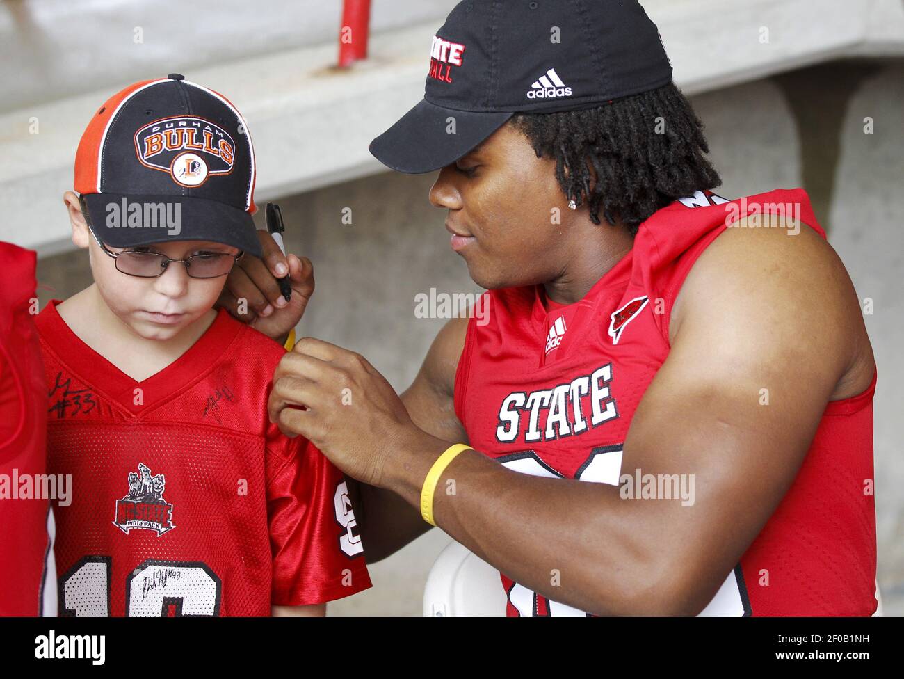 North Carolina State's Anthony Creecy (26), right, signs the shirt of ...