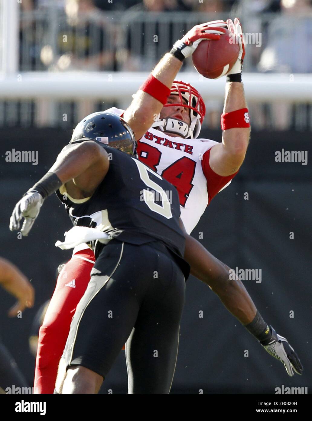 North Carolina State's George Bryan (84) pulls in a one-handed ...