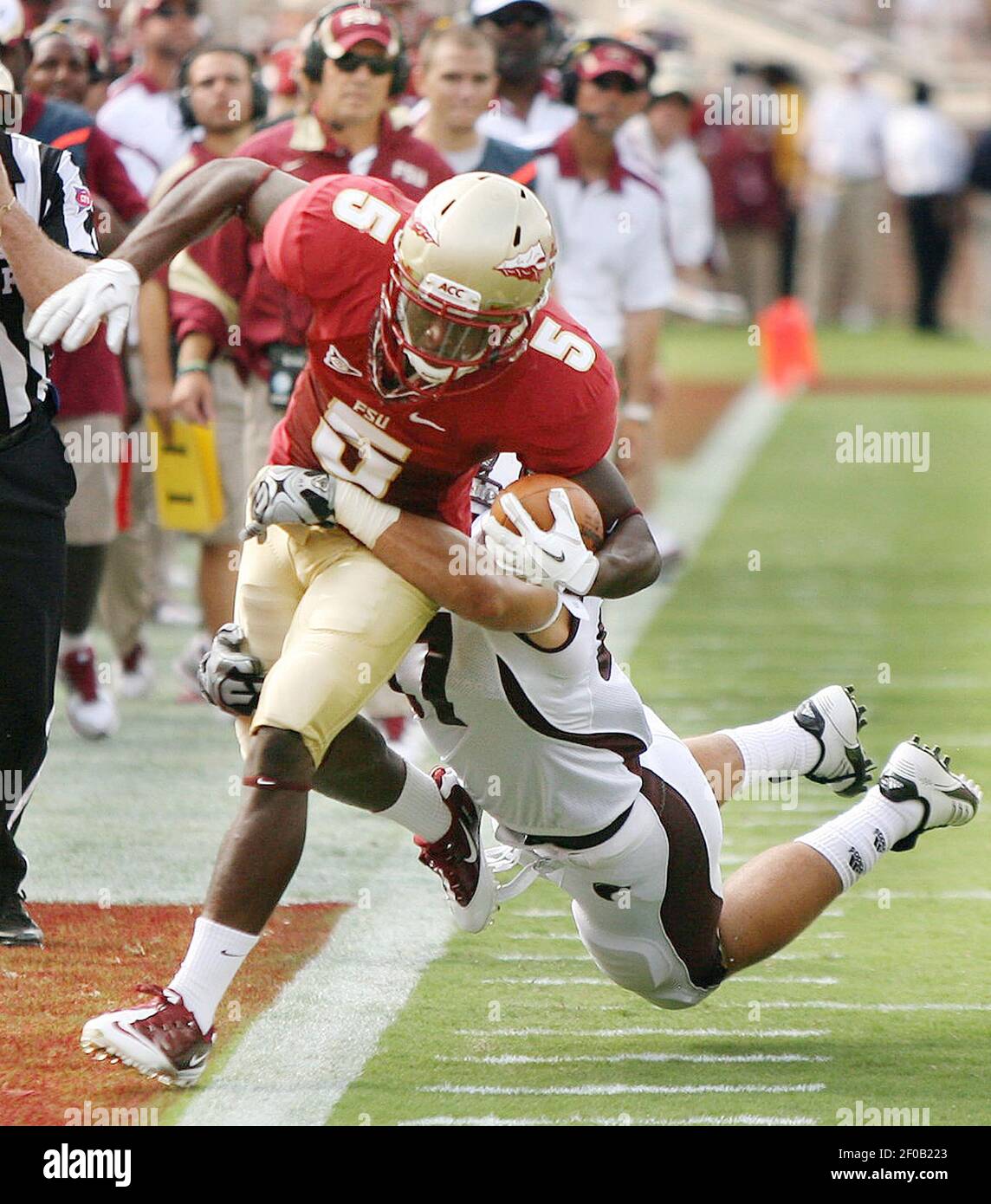 Florida State's Greg Reid drags Louisiana-Monroe safety Darius Prelow ...