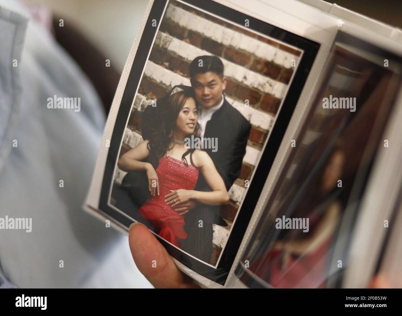 Fawn Lee shows wedding photos of her and her husband, Rick Pham. Lee ...
