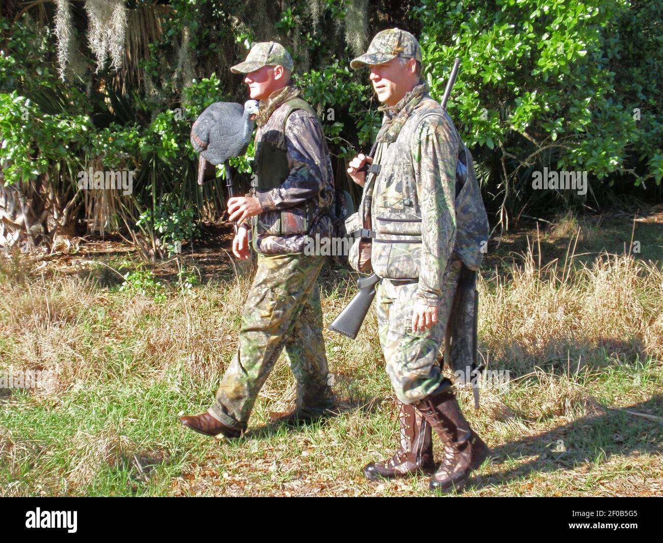 Fort Drum hunting guide Cody Storey, left, carries a decoy as he and ...