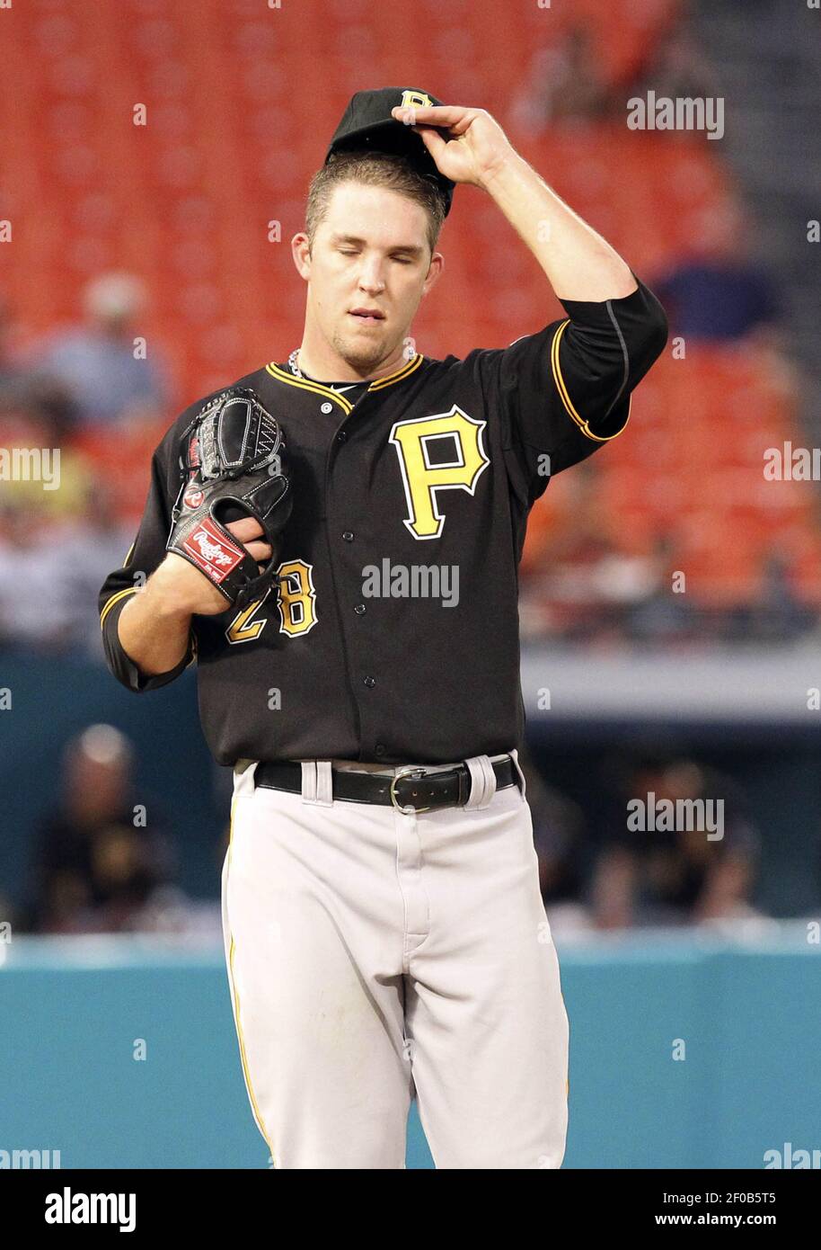 Pittsburgh Pirates pitcher Paul Maholm fixes his hat during third ...