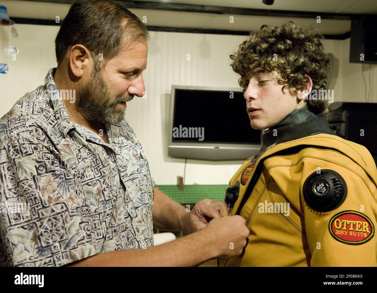 World-renown scuba diver Jeff Bozanic, left, helps his son Evan, 13 ...