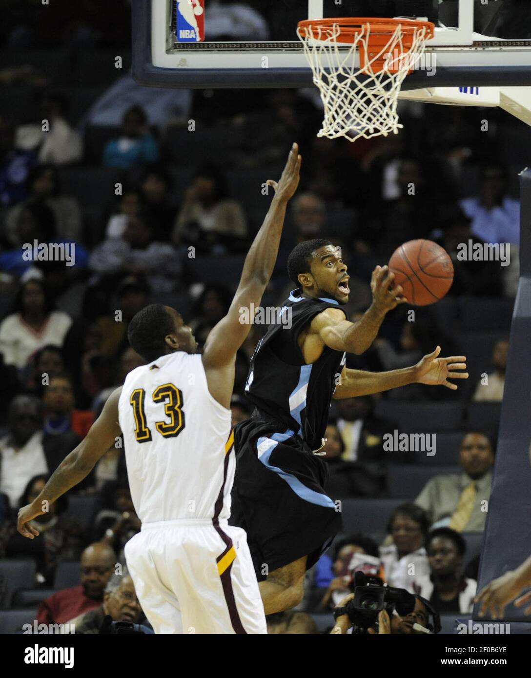 Livingstone's Quintin Redfern, right, drives past Shaw's Darryl Johnson ...