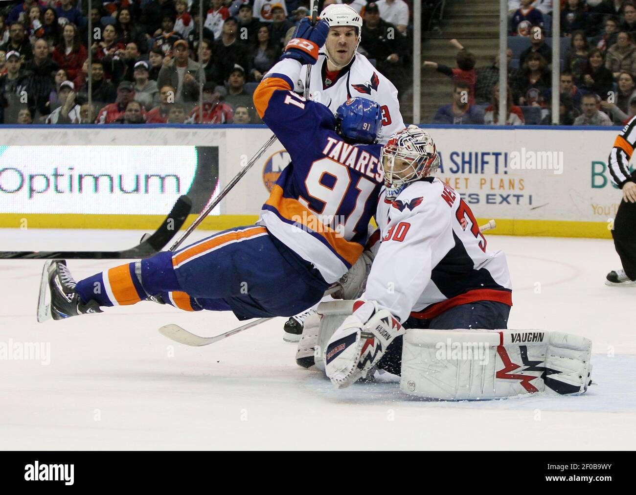 John Tavares (91) of the New York Islanders is checked into Michal ...