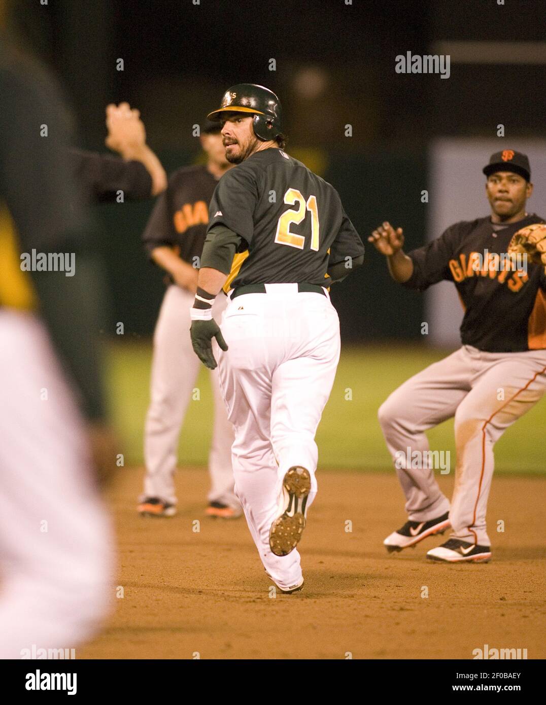 Oakland Athletics' Andy LaRoche (21) looks back at pursuit from San ...