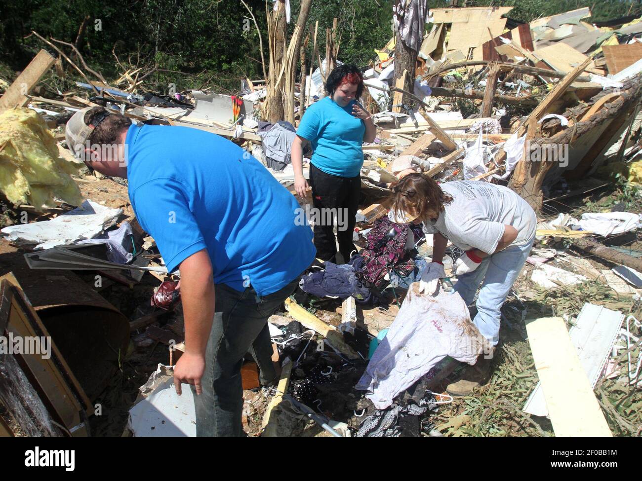 Justin Hardeman, from left, Danielle Crabtree and Sandra Irby salvage ...