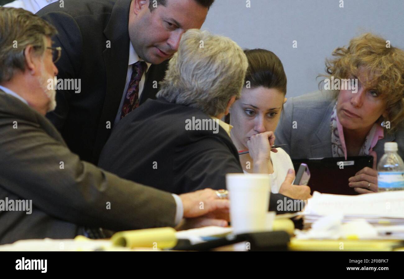 Casey Anthony confers with her defense team including Cheney Mason ...