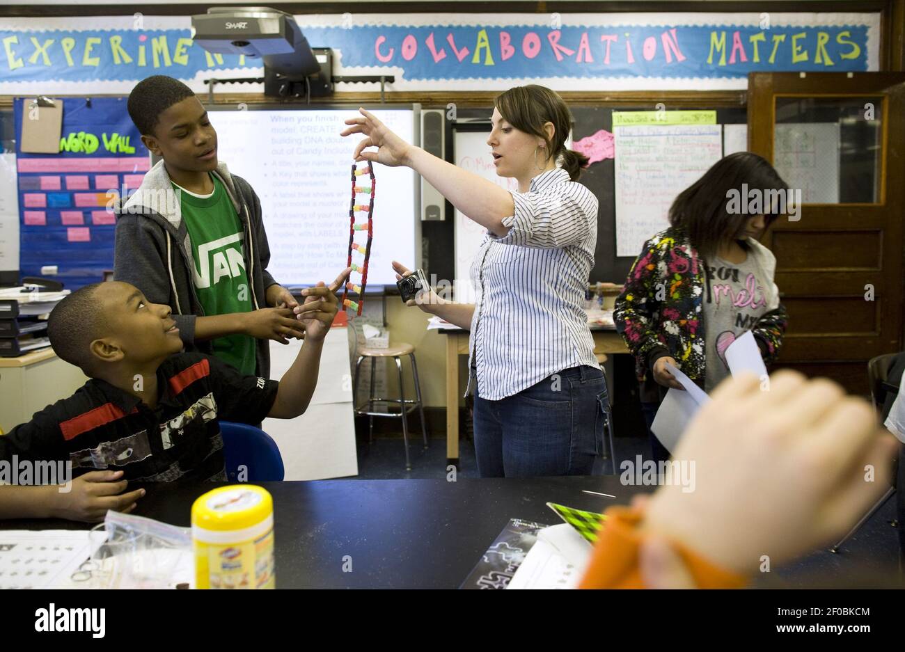 Teacher Leah Hirsch, right, discusses a DNA helix made out of candy ...