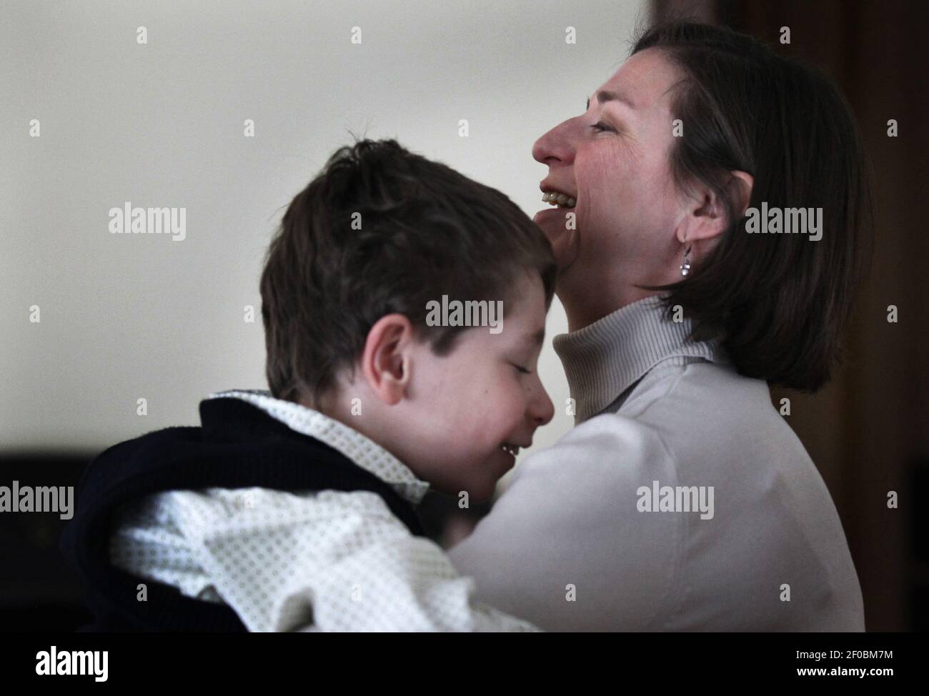 Amy Dawson hugged her son, Mac. during a morning therapy session at ...