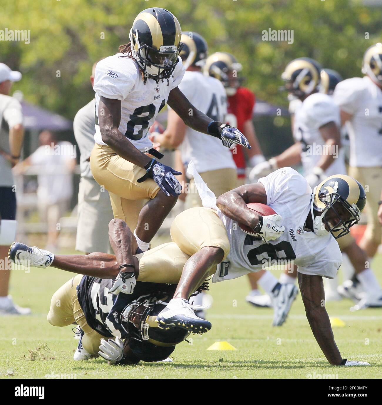 St. Louis Rams wide receiver Joe West, right, is tackled by cornerback ...