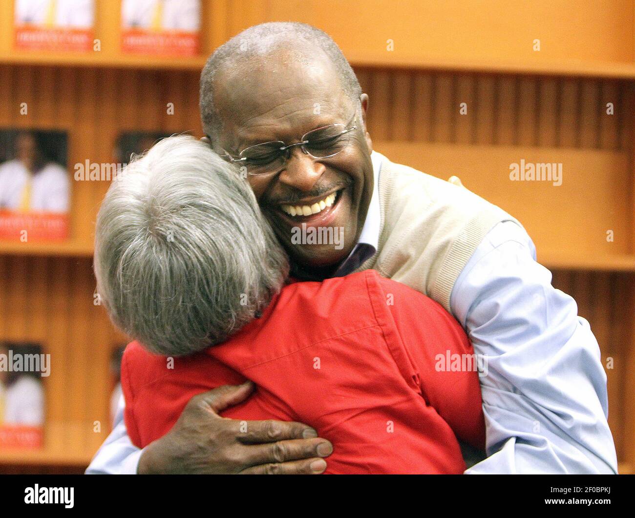 2012 Republican presidential candidate Herman Cain, facing camera, gets ...