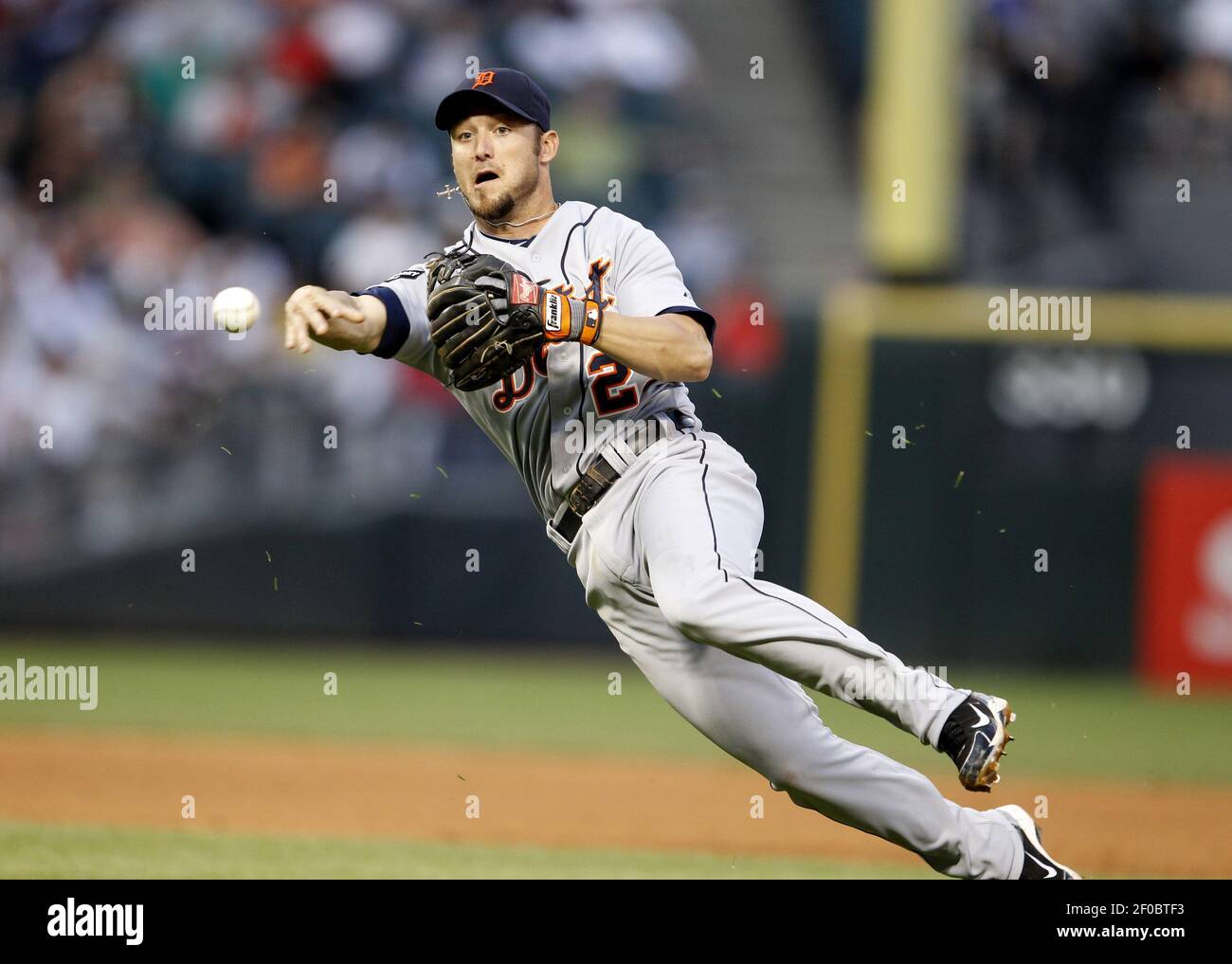 Detroit Tigers second baseman Ryan Raburn (25) throws to first base ...