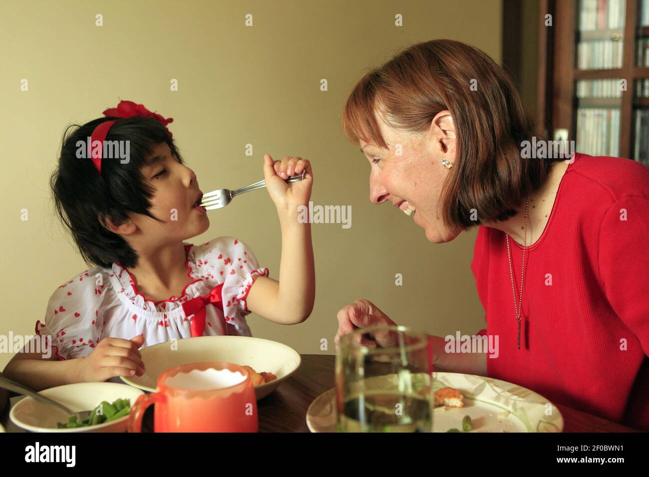 Aihua Sprecher, 6, left, who is blind, clowns with her mother, Paula ...