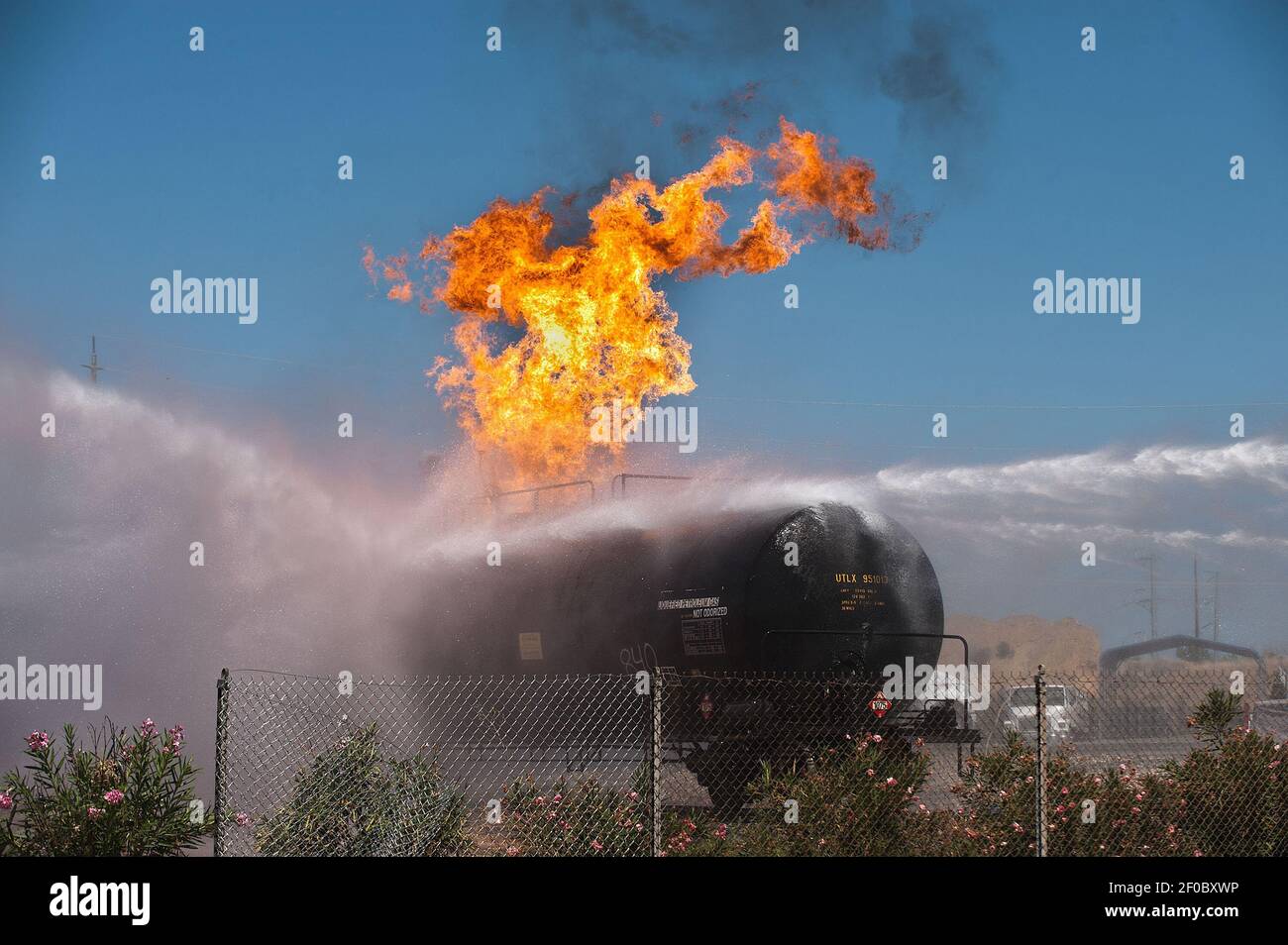 Firefighters spray water on a railroad tanker leaking propane in ...