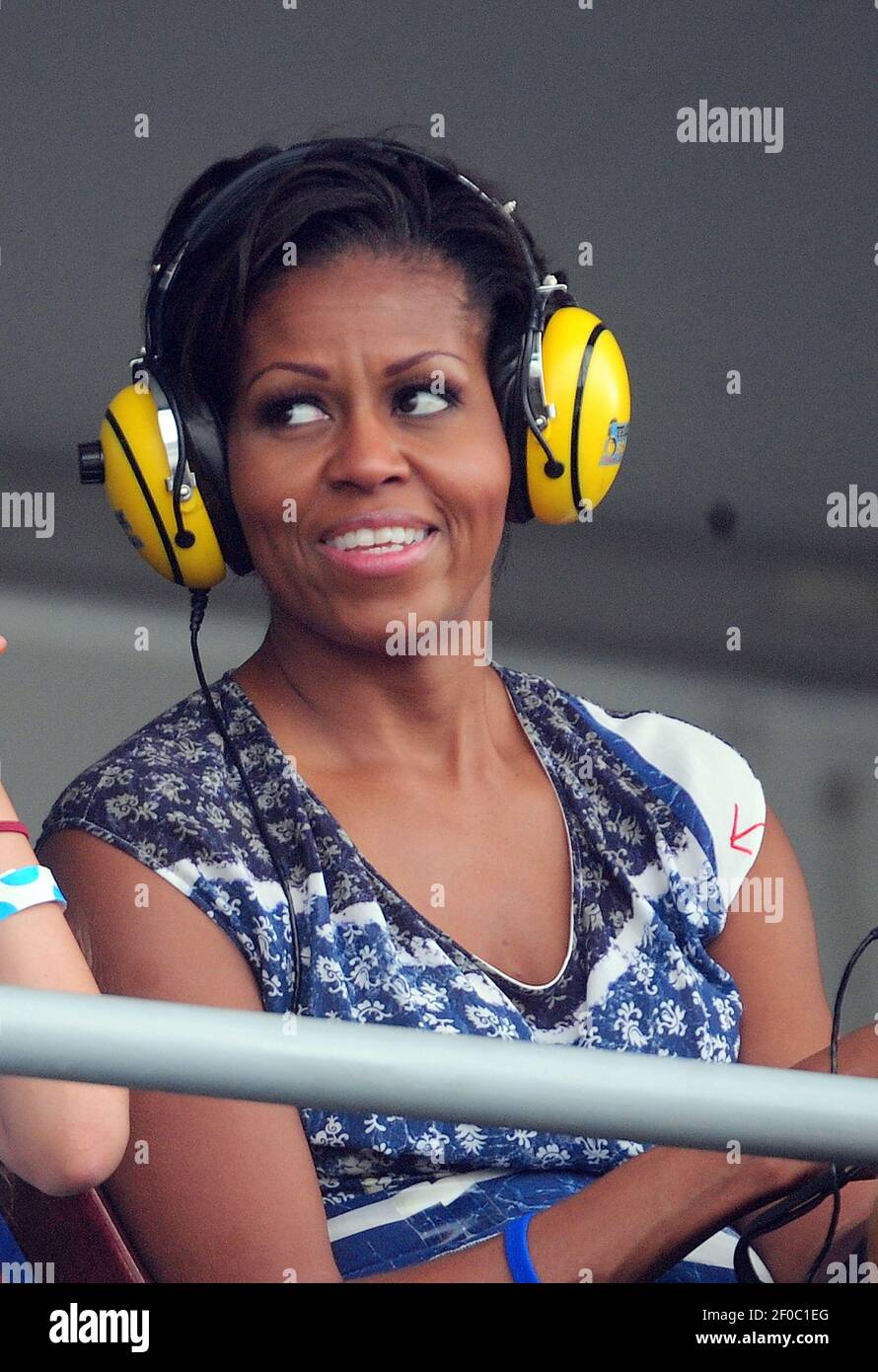First lady Michelle Obama wears headphones as she watches the Ford 400 ...