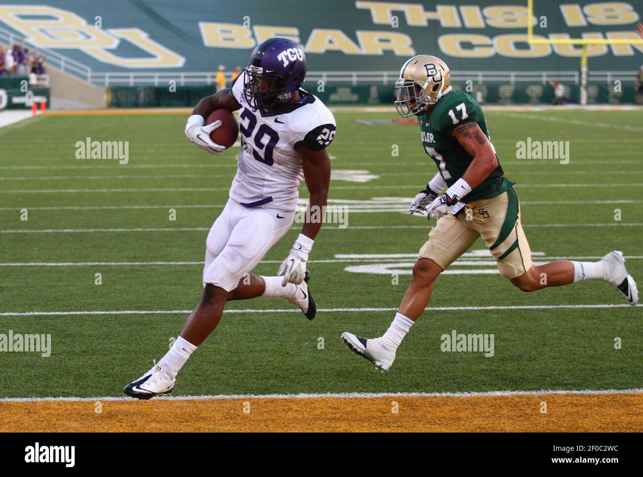 Texas Christian University running back Matthew Tucker (29) runs in past Baylor safety Mike ...