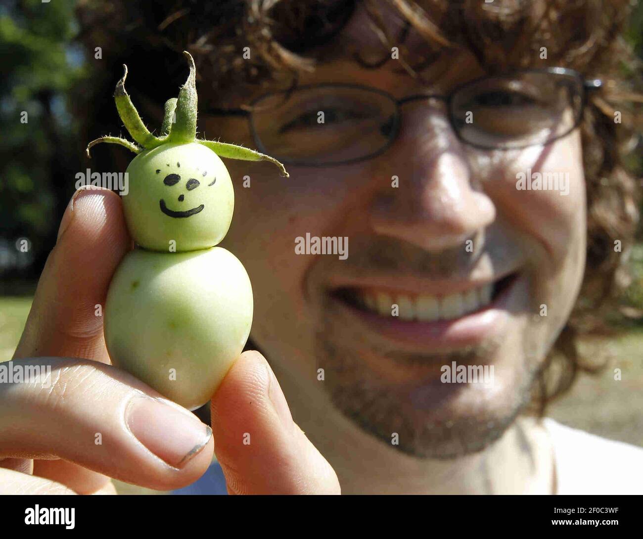 Stan Butler shows off a double tomato on August 13, 2011. Butler co ...