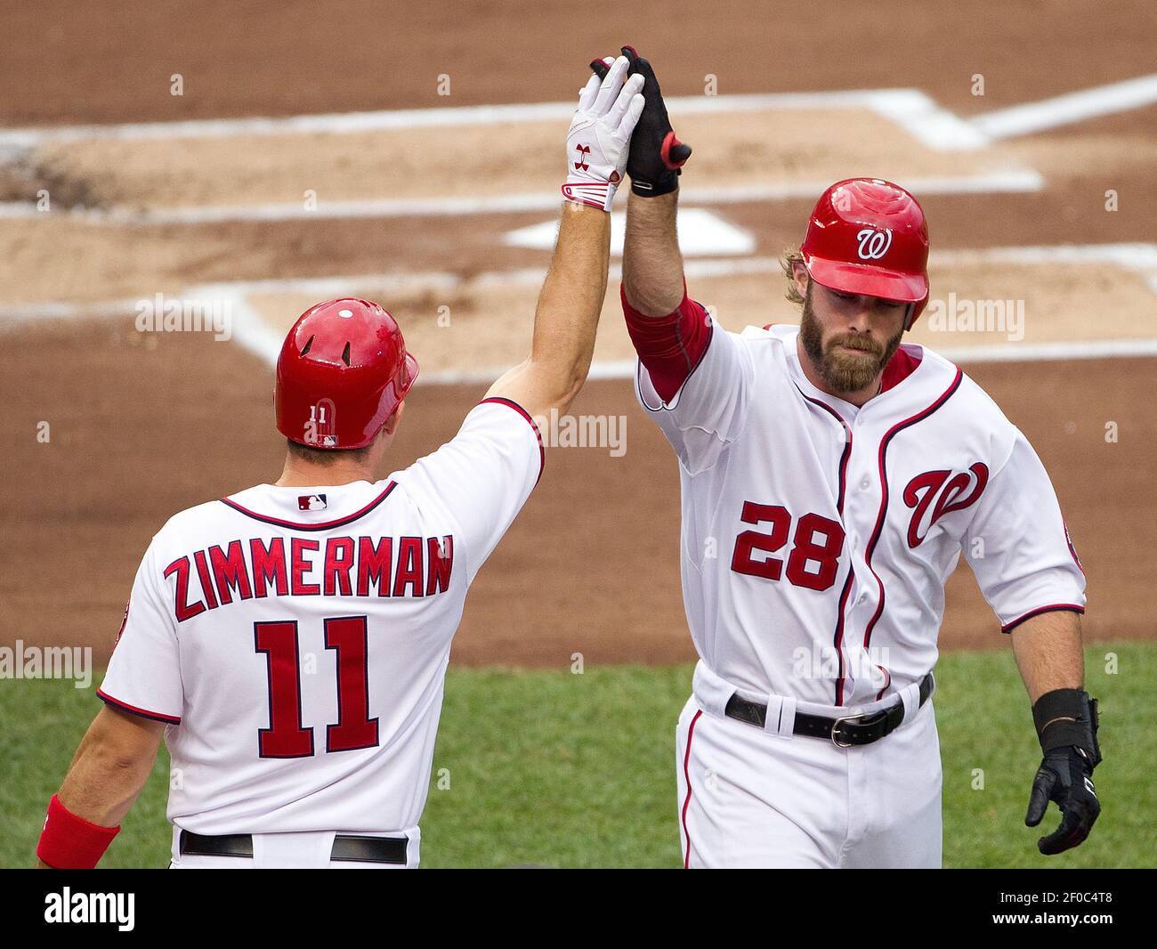 Washington Nationals right fielder Jayson Werth (28) is greeted by ...