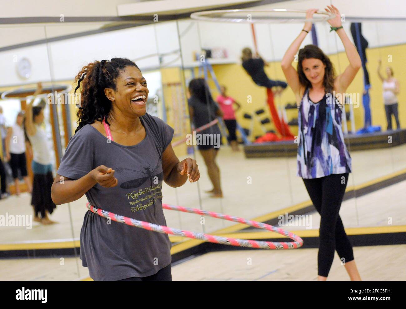 Shanita Starks, left, of Hamilton, laughs during a hoop fitness class ...