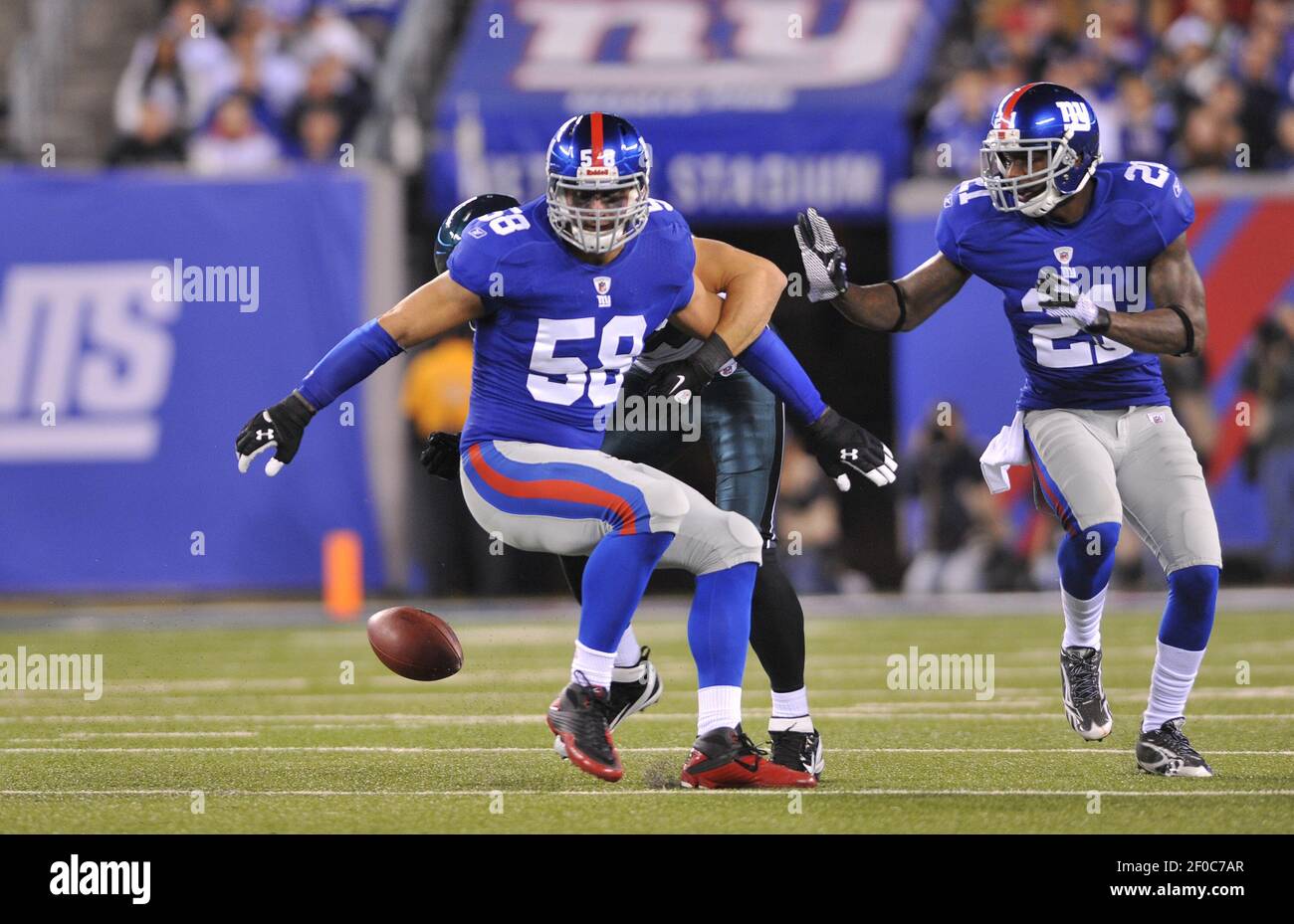 Mark Herzlich of the New York Giants (58) gets tangled up with a ...