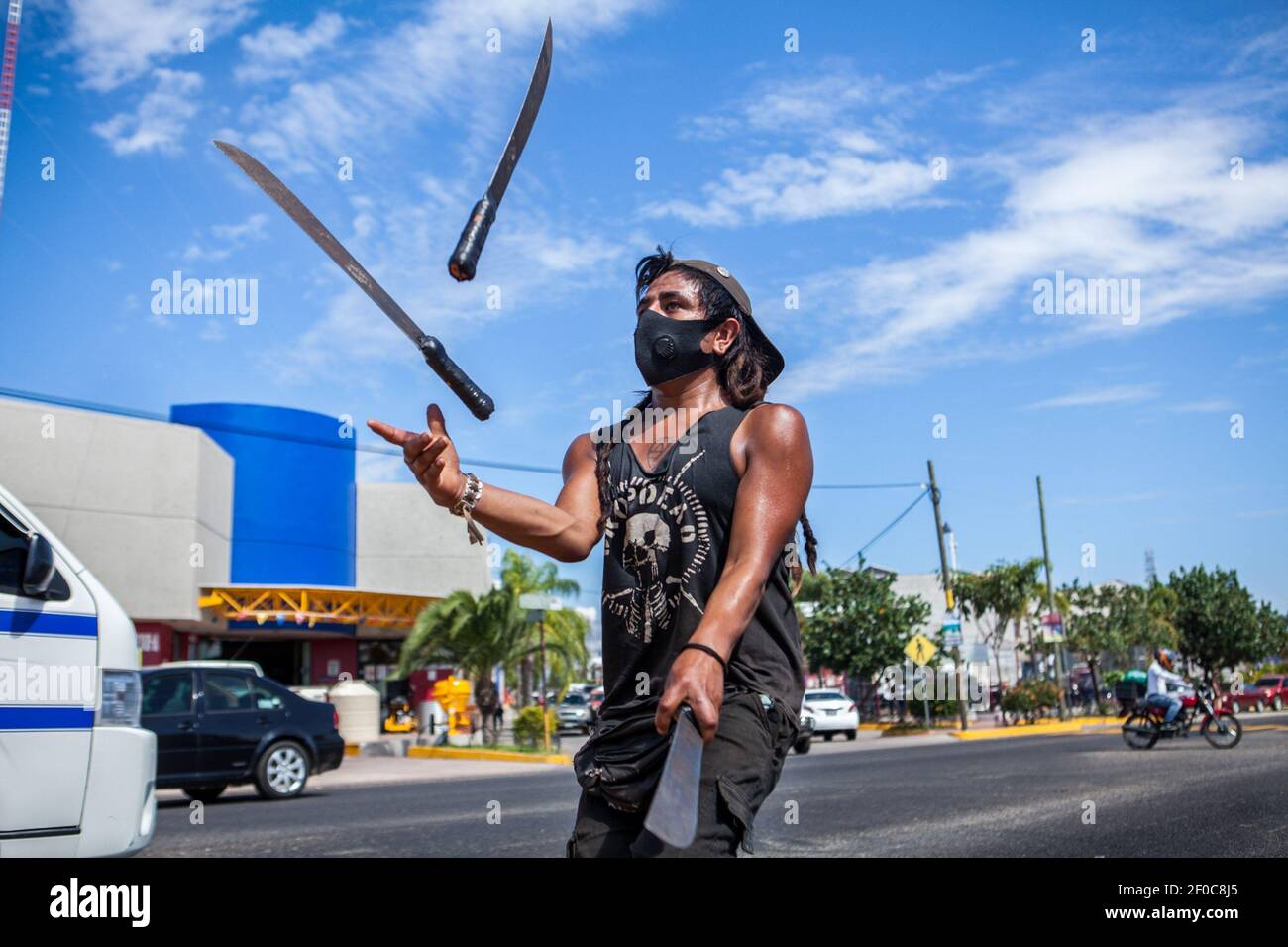 Puerto Escondido, Mexico. 12th Feb, 2021. A street juggler wearing a ...
