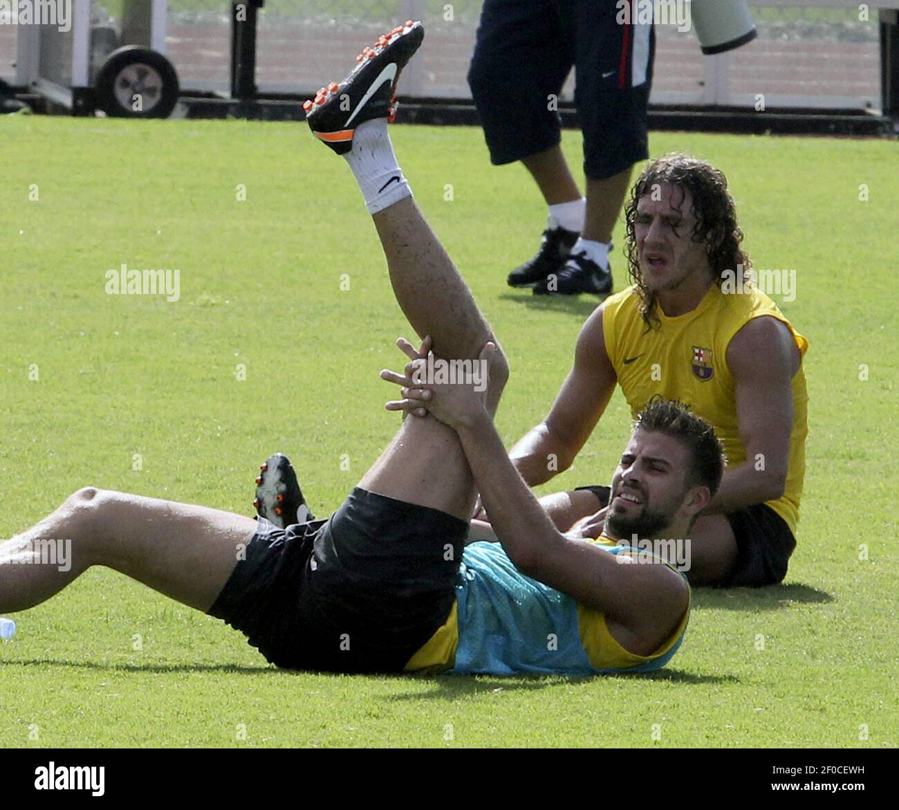 Carles Puyol, back, and Gerard Pique from FC Barcelona stretch during ...