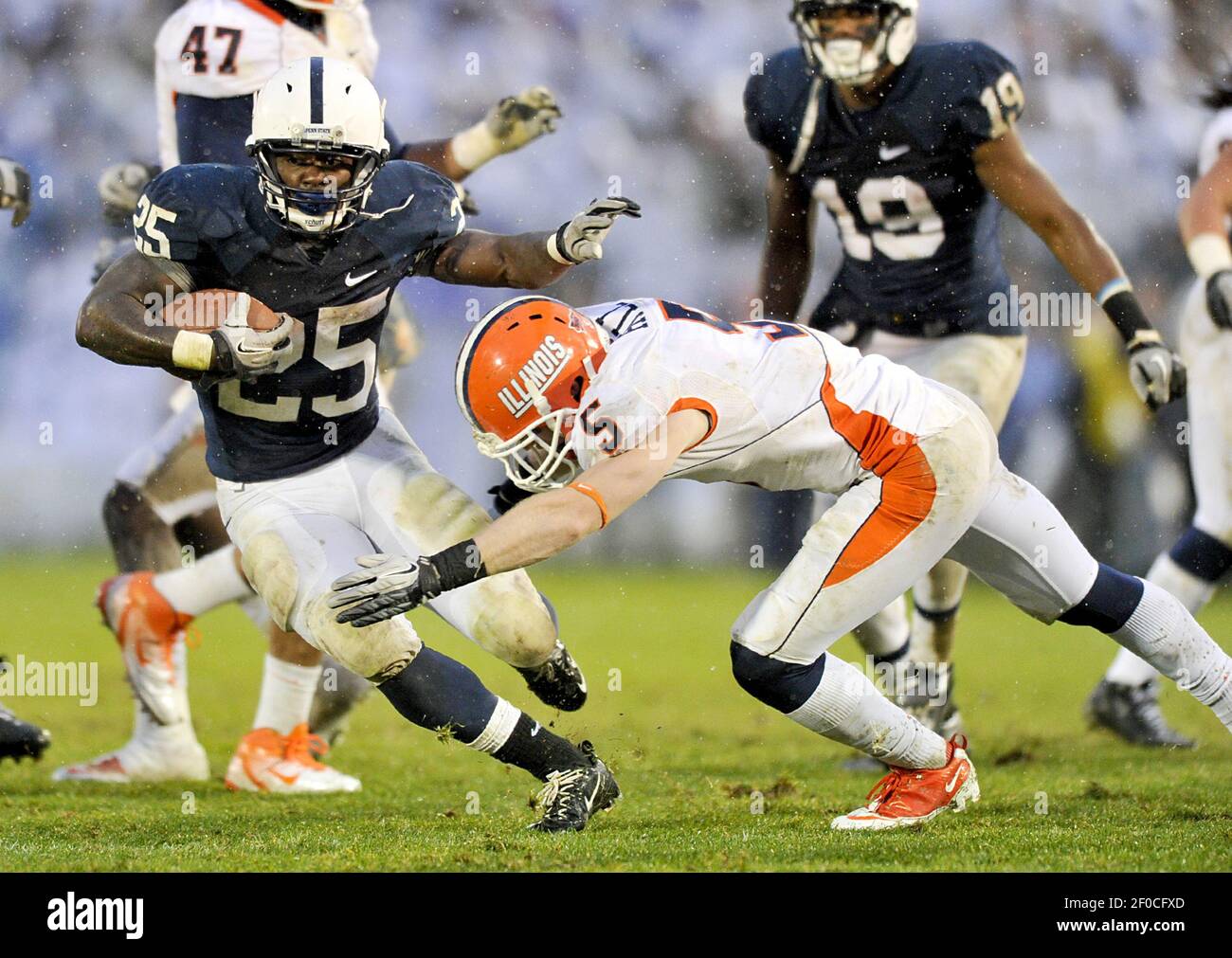Penn State's Silas Redd cuts around Illinois defender Steve Hull at Beaver Stadium in University ...
