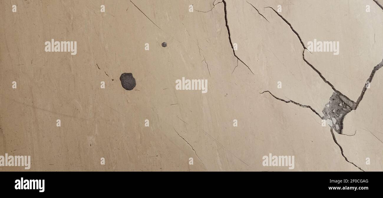 Broken wall texture with old paint. The consequences of the earthquake ...