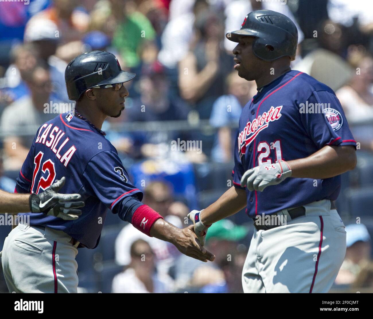Minnesota Twins' Delmon Young (21) and Alexi Casilla (12) celebrate ...
