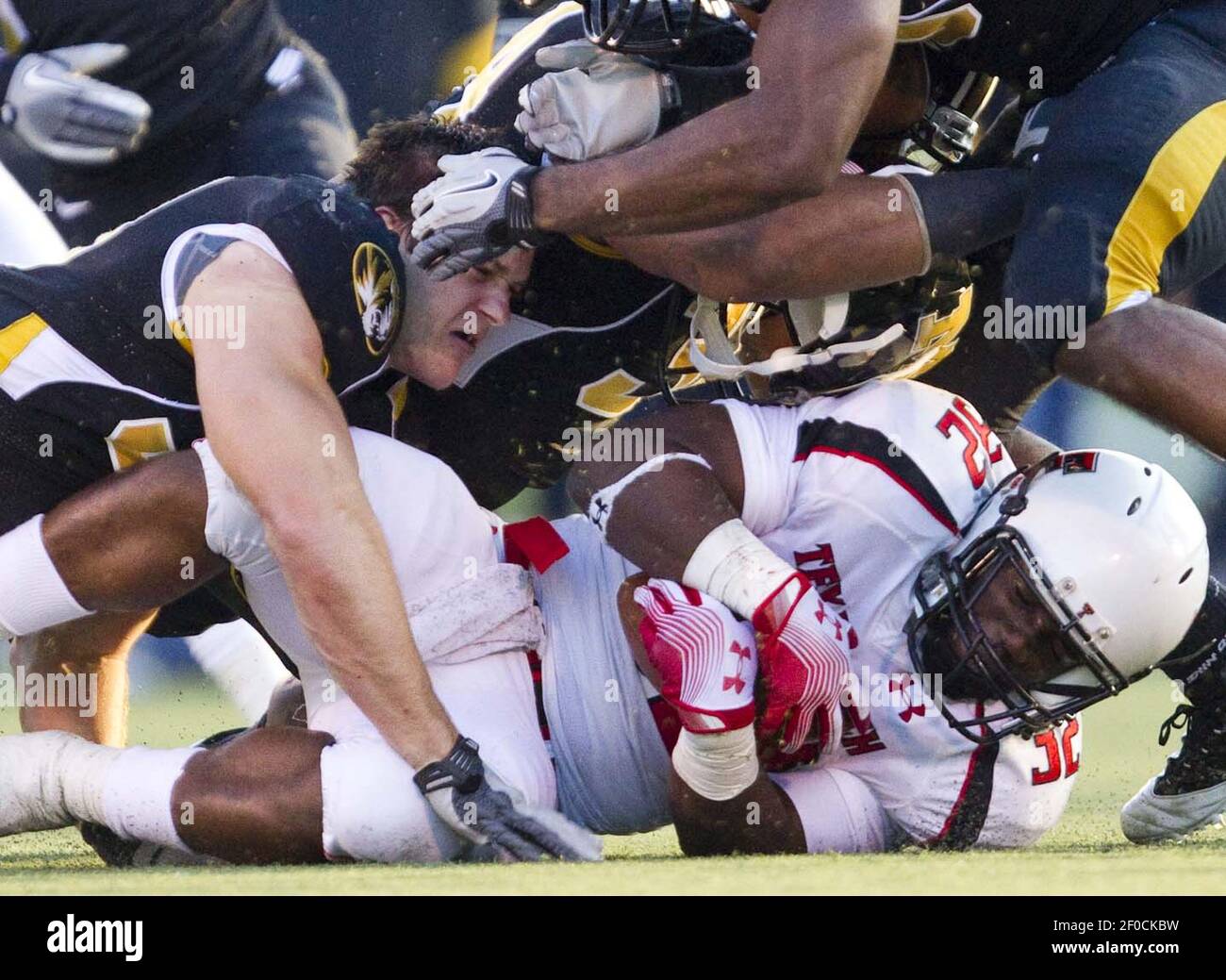 Missouri linebacker Luke Lambert (33) loses his helmet as he tackles ...