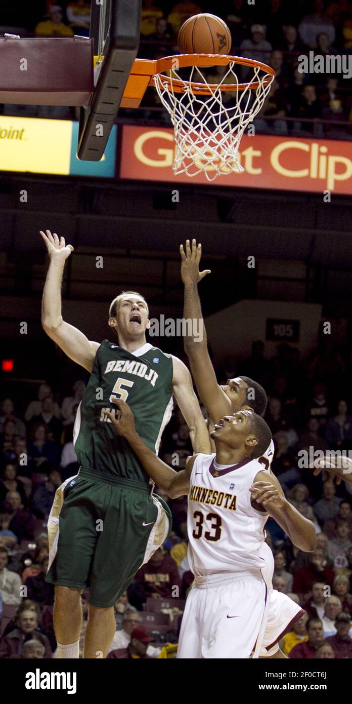Bemidji State's David Berthene, left, scores over Minnesota's Ralph ...